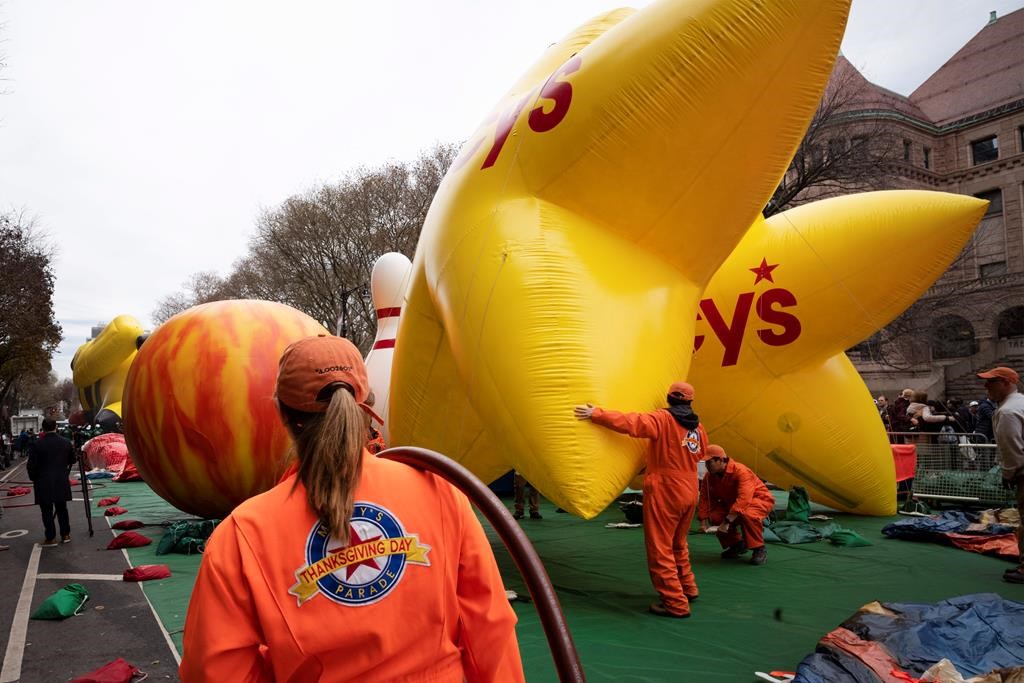 The Latest: Beloved balloons will fly in parade