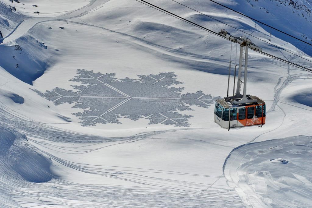 Artist uses snow as canvas for massive geometrical designs
