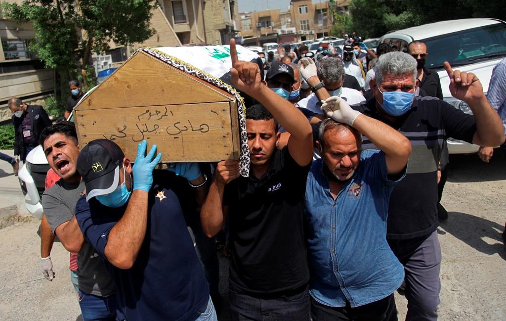 Iraqis mourn expert on armed groups killed by unknown gunmen