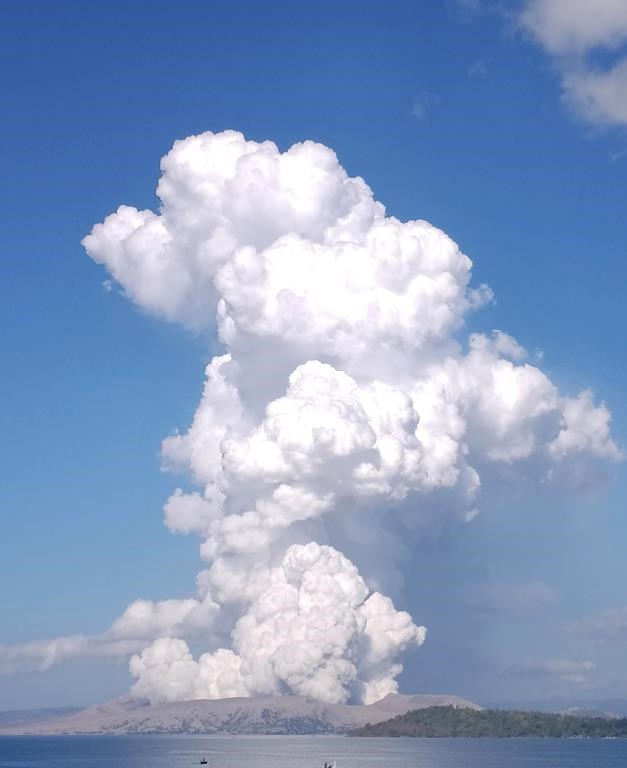 Philippine volcano near capital spews ash and gas