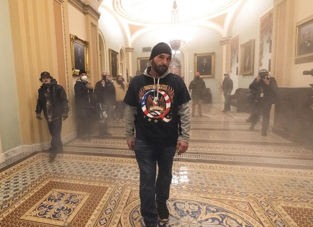 Trial opens for QAnon follower who chased officer at Capitol