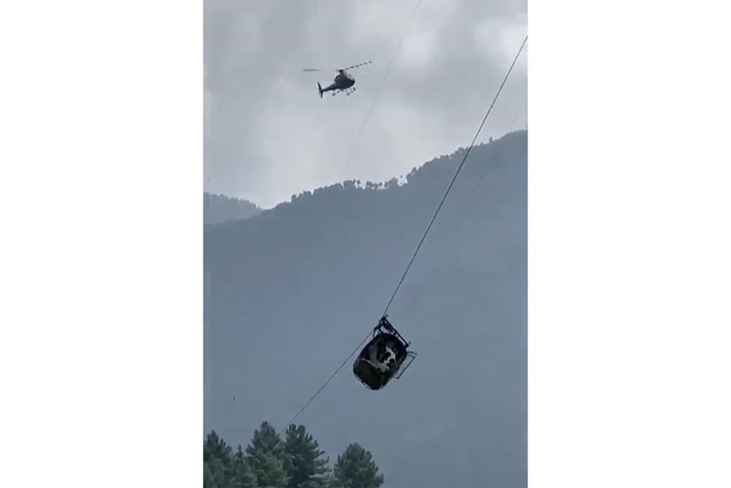 Rescuers save 8 people trapped in cable car dangling above canyon in ...