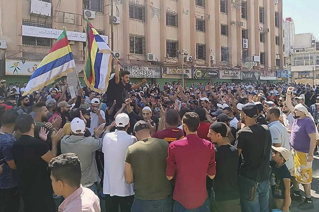 Residents in southern Syria raid ruling party offices, block road as ...