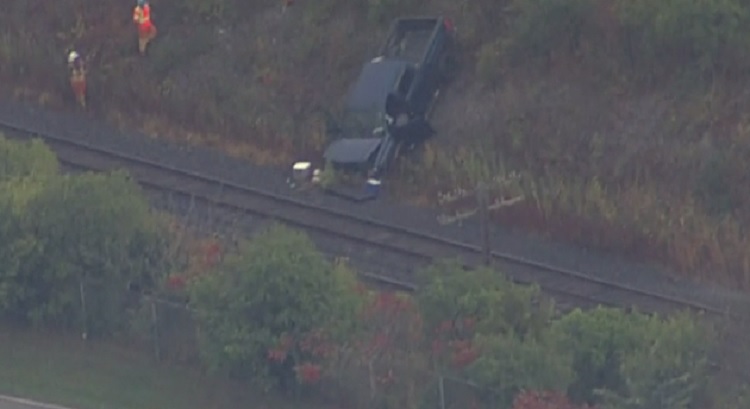 Pickup truck crashes into ditch near train tracks in Pickering