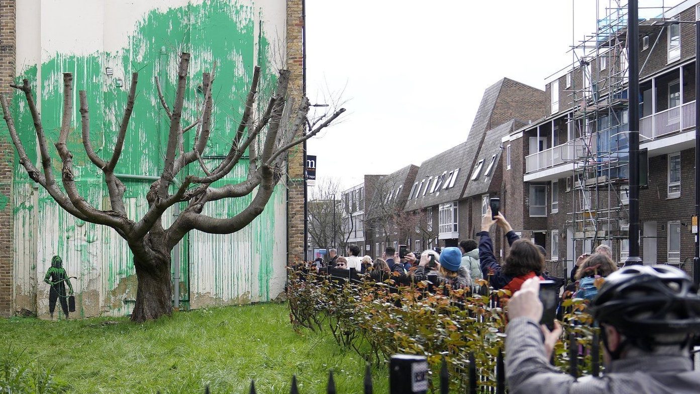 A new Banksy mural sprouts beside a cropped tree in London. Many see an ...